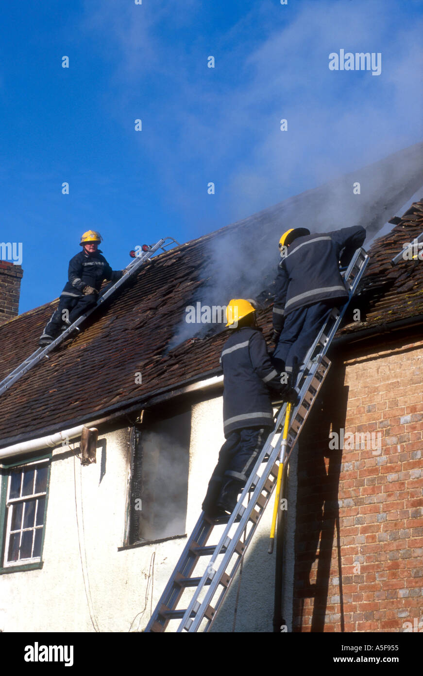 Firefighters at a house fire Stock Photo - Alamy