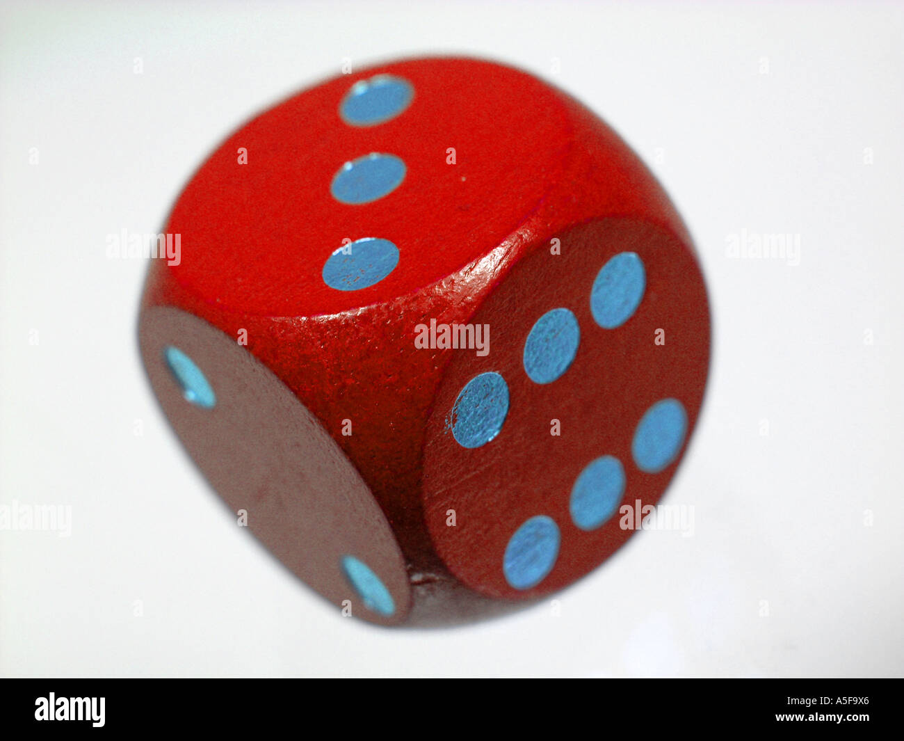 Red wooden dice against a white background Stock Photo - Alamy