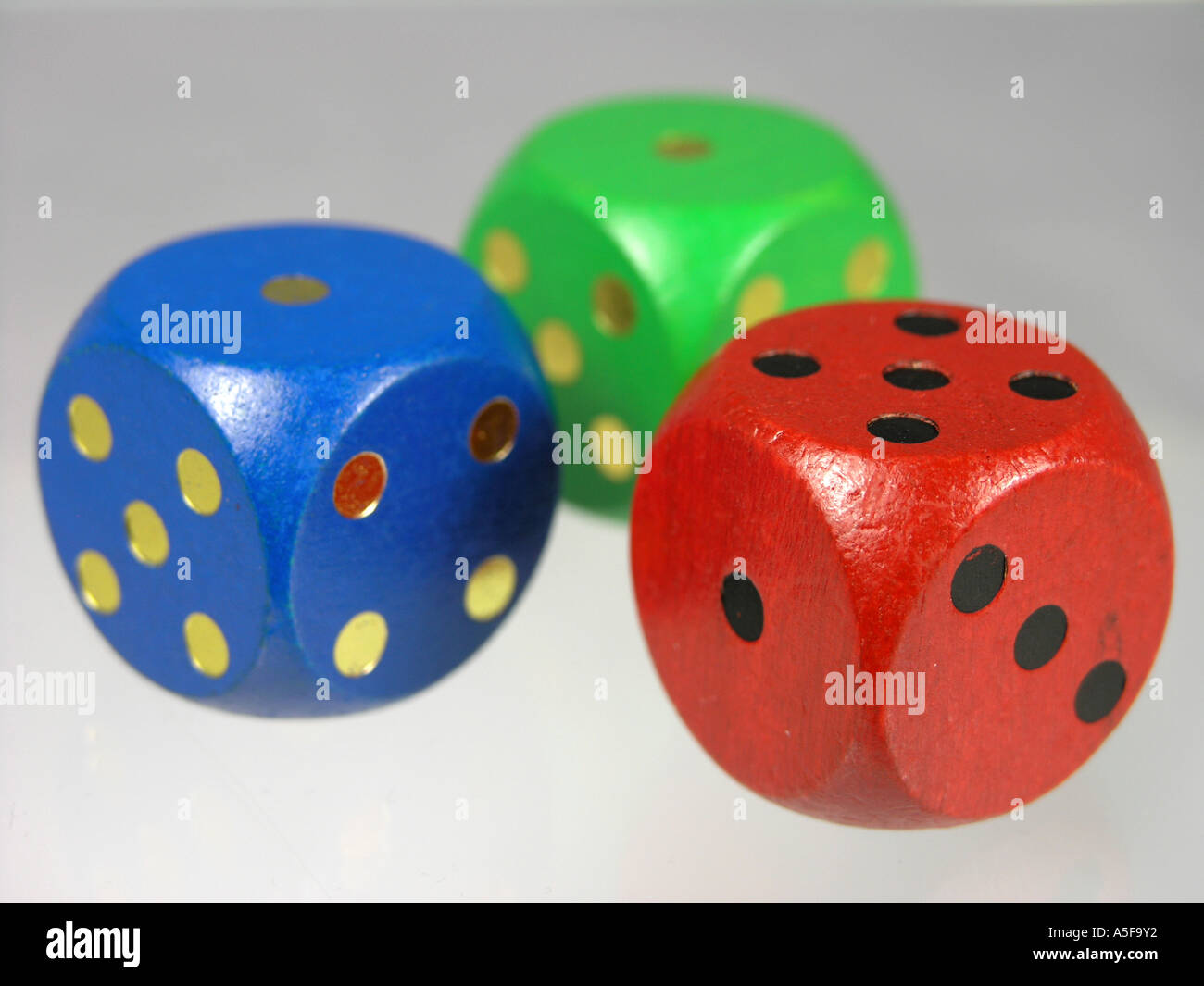 Three Wooden Coloured Dice Stock Photo - Alamy
