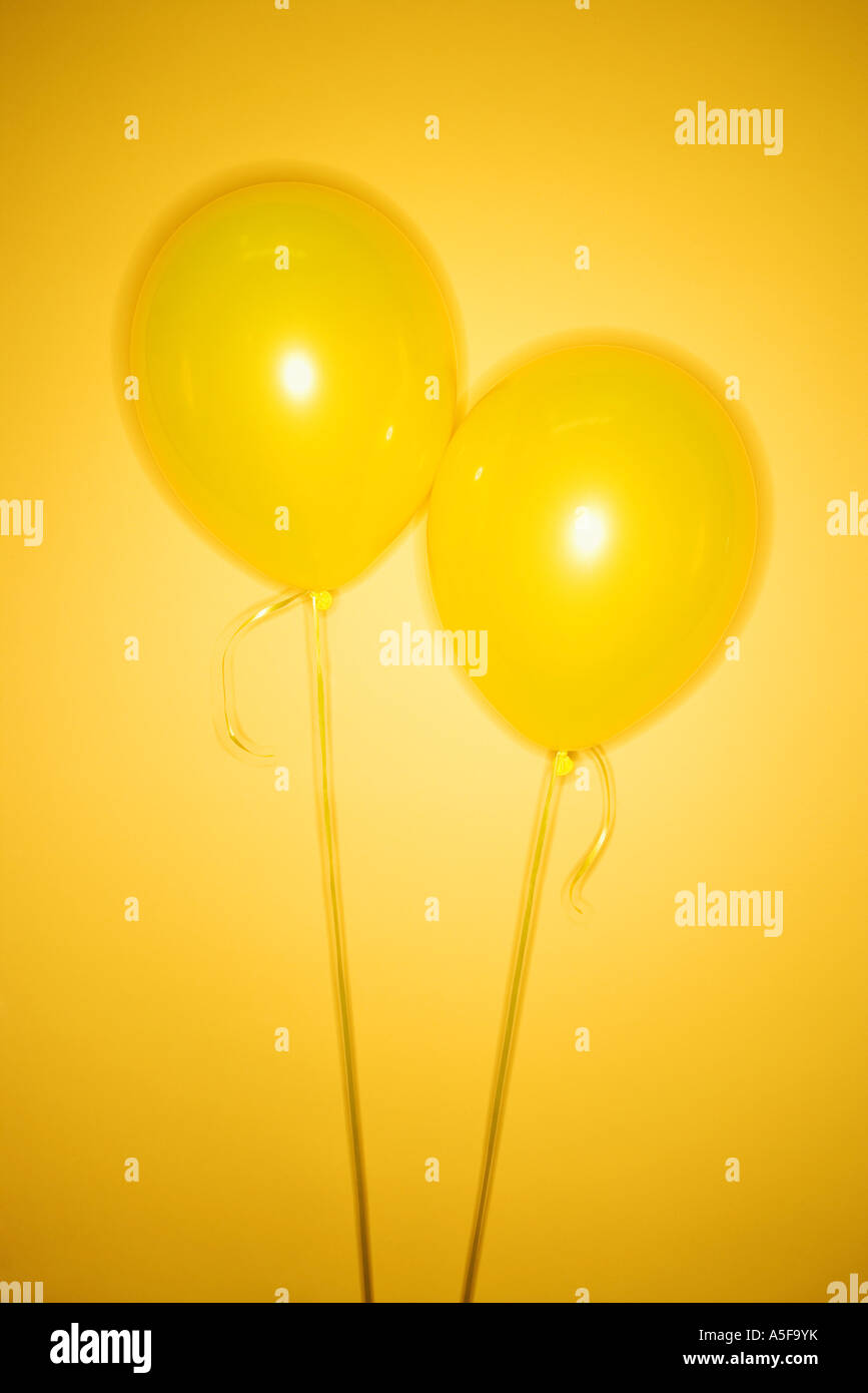 Still life of yellow balloons on yellow background Stock Photo - Alamy