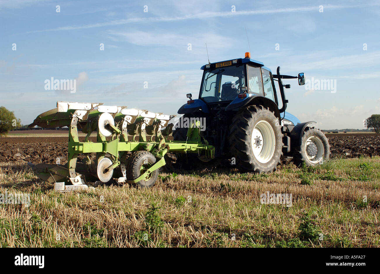 Tractor ploughing and planting wheat crops hi-res stock photography and ...