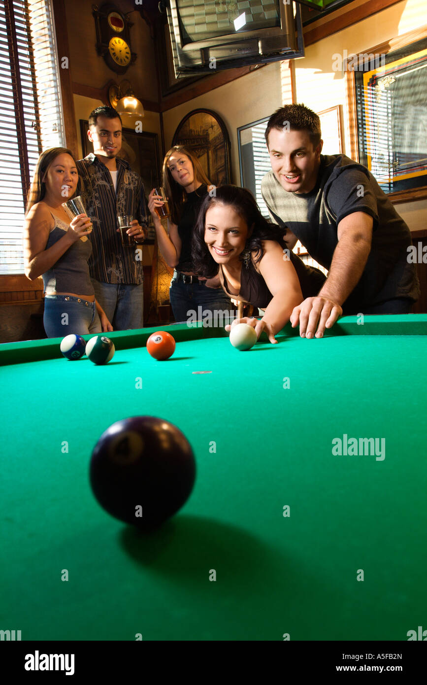 Young caucasian woman receiving advice on shooting pool ball while ...