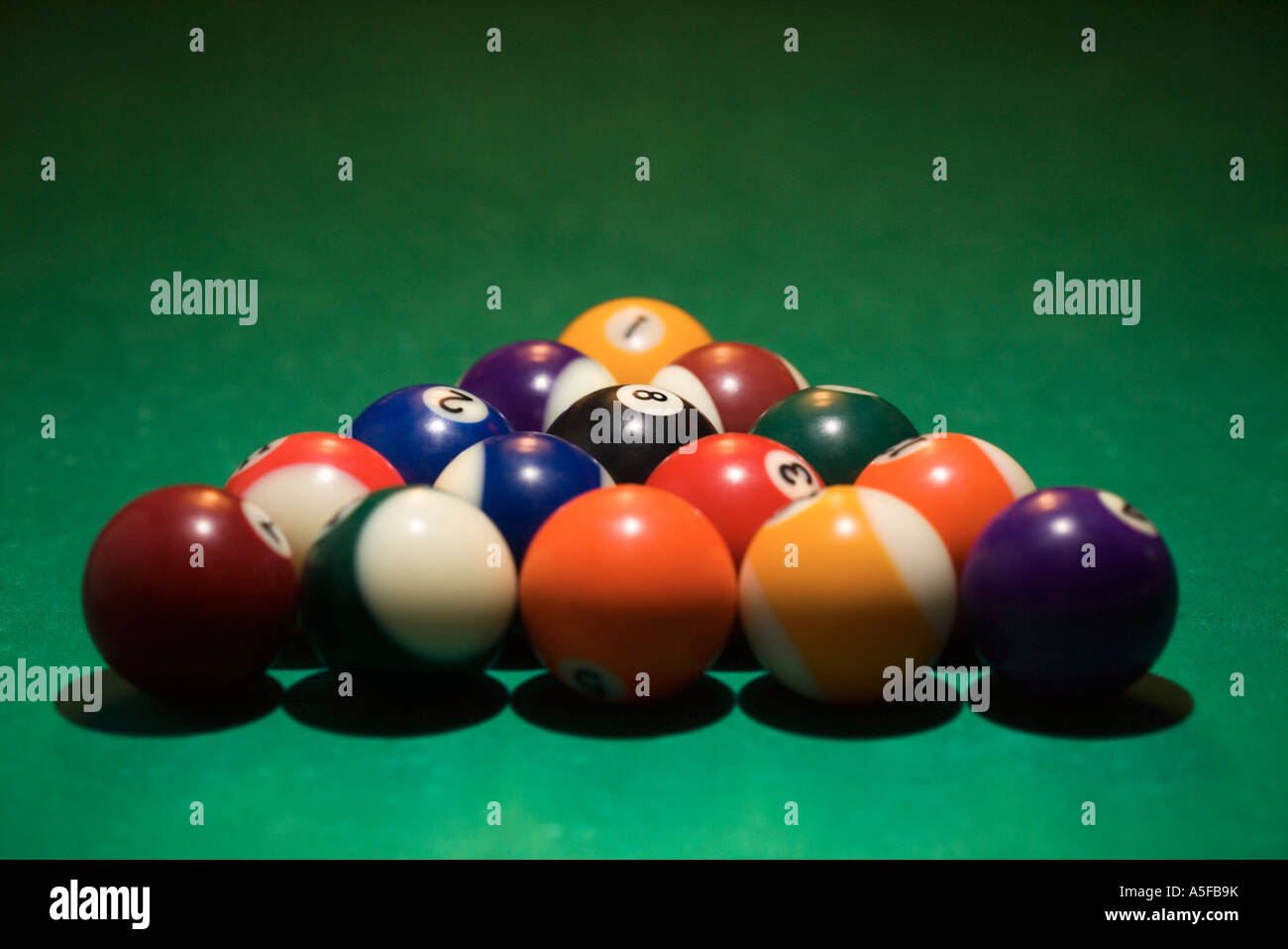 Rack of pool balls on green billiards table Stock Photo - Alamy
