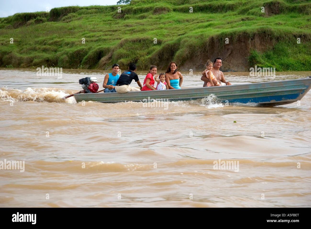 Brazilians ride in a small river boat on the Amazon River near Manaus ...