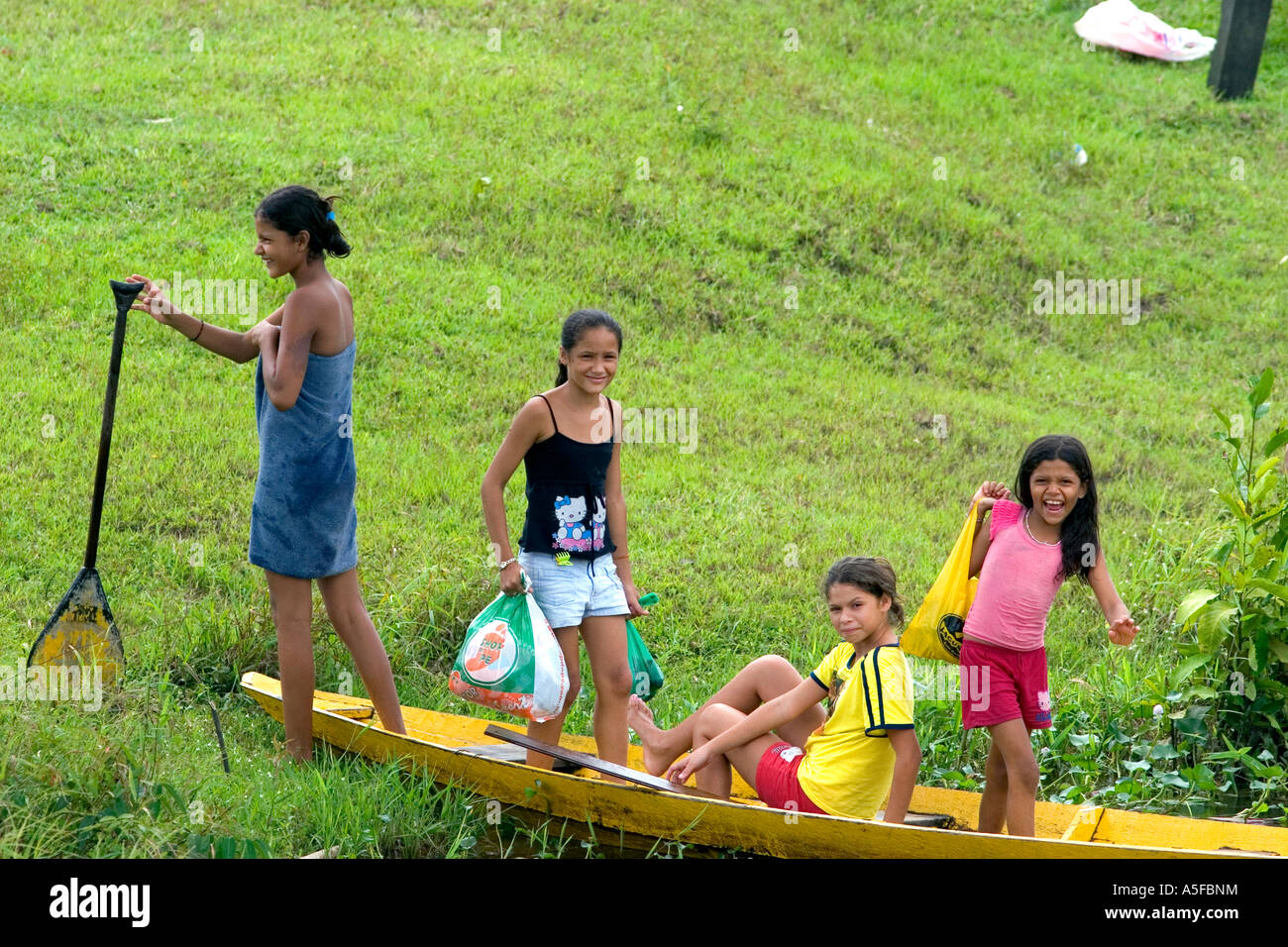 Brazilian girls in a canoe in the Amazon jungle near Manaus Brazil ...