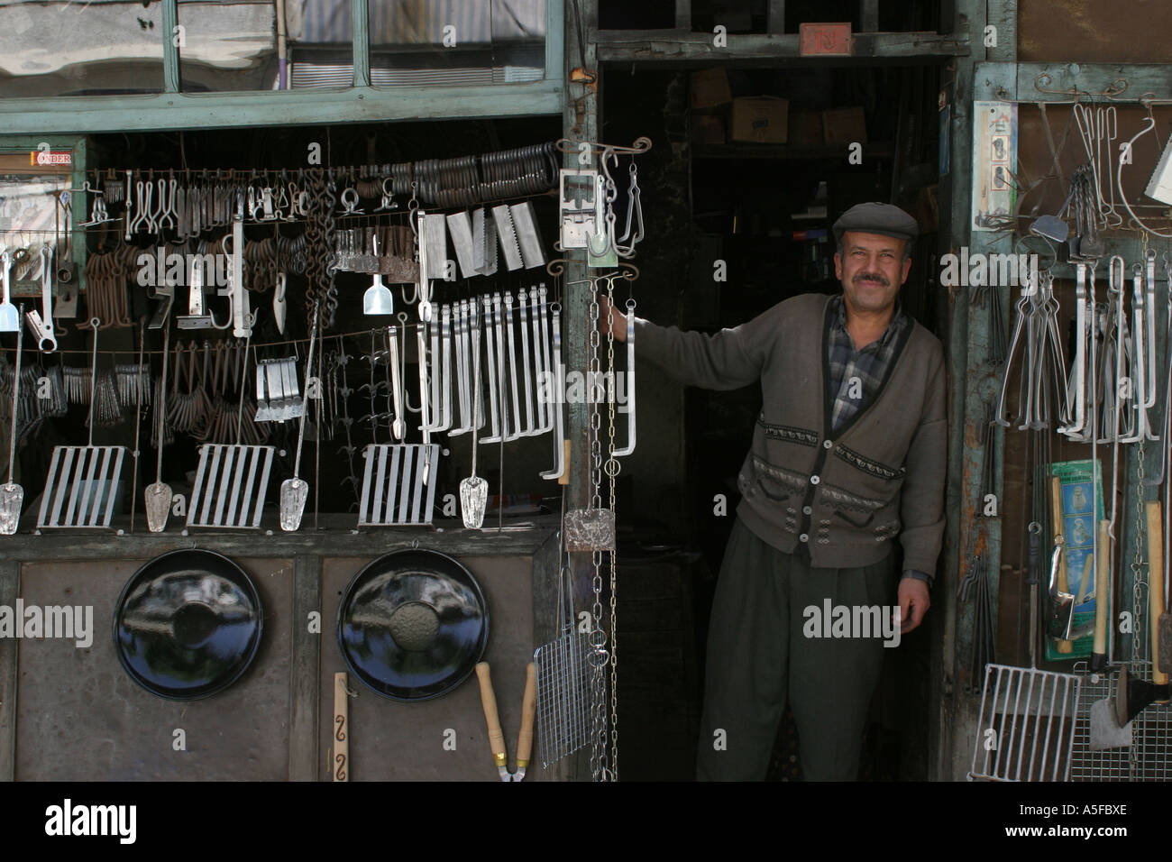 Turkish ironmonger shopkeeper in shop doorway Stock Photo - Alamy