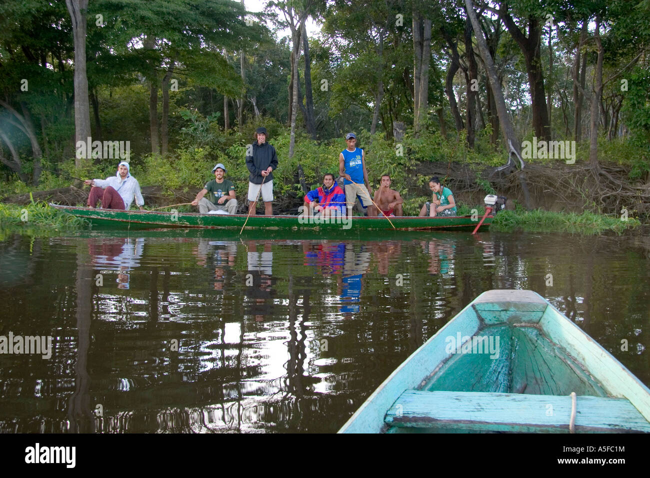 People fishing from a dugout canoe on the Arasa River in the Amazon ...