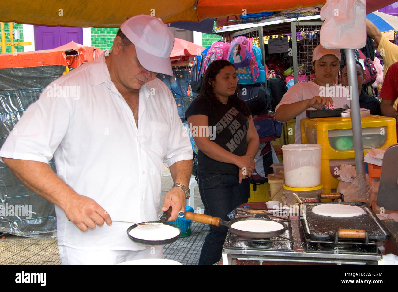 A man cooking tapioca into a kind of pancake in Manaus Brazil Stock ...