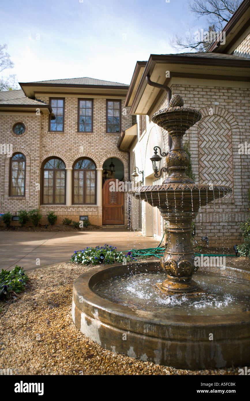 Outdoor front view of affluent home with fountain Stock Photo - Alamy