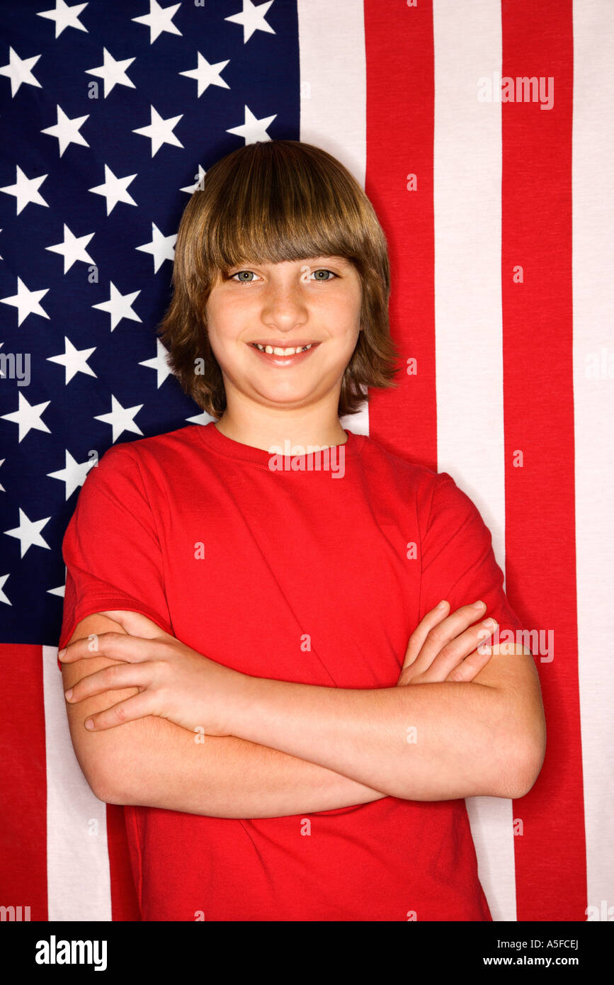 Portait of Caucasian boy with arms crossed with American flag in ...