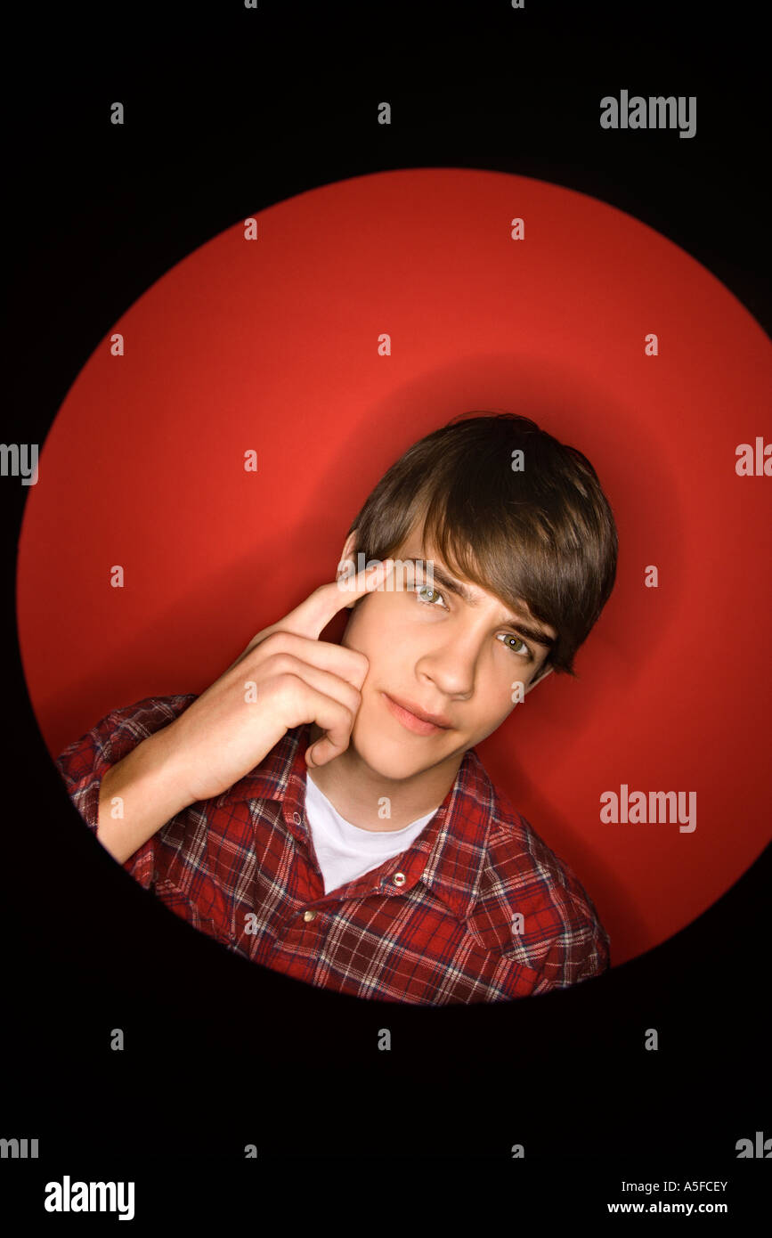 Portrait of Caucasian teen boy pointing to his head Stock Photo - Alamy