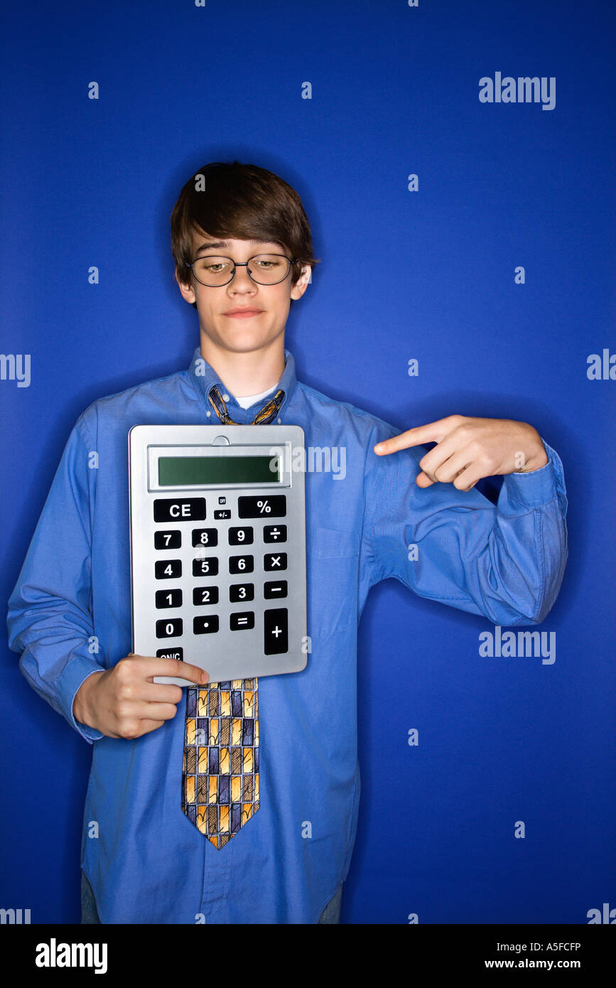 Portrait of Caucasian teen boy holding and pointing to oversized ...