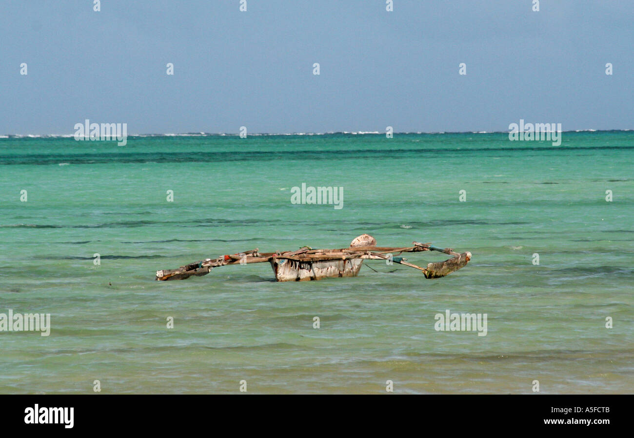 Wooden Outrigger Canoe floating in the water off the east coast of ...