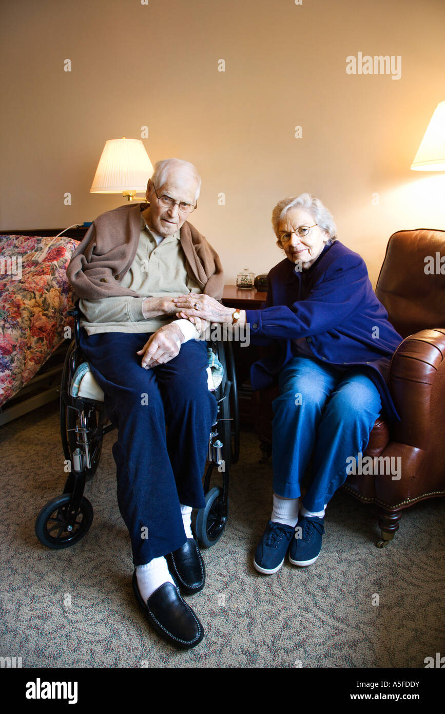 Elderly Caucasian couple in bedroom at retirement community center ...