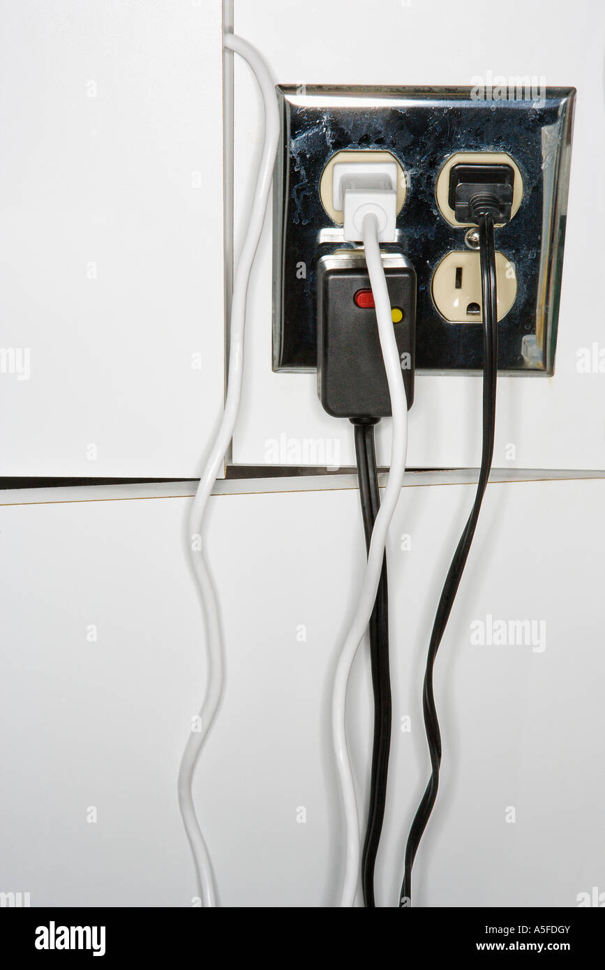 Electrical outlet with multiple plugs and cords Stock Photo - Alamy