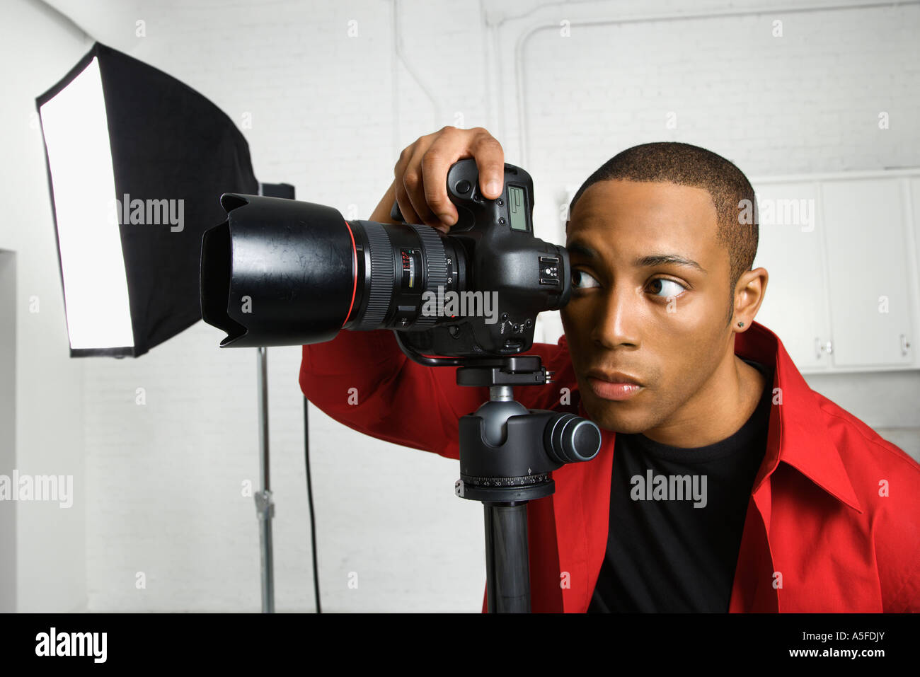 Photographer work looking through camera hi-res stock photography and ...