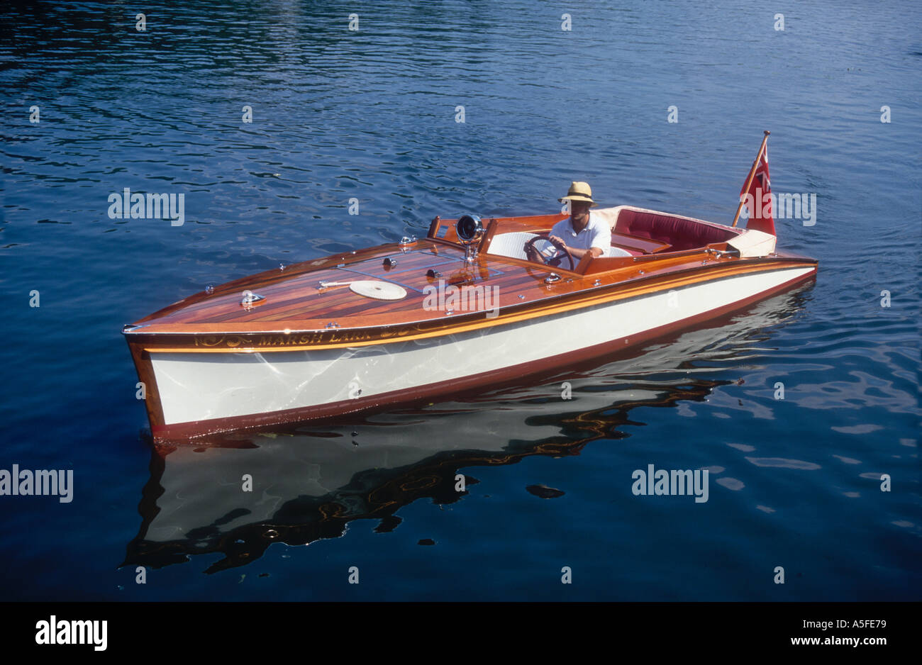 A young man in an electric powered slipper launch Henley on Thames ...