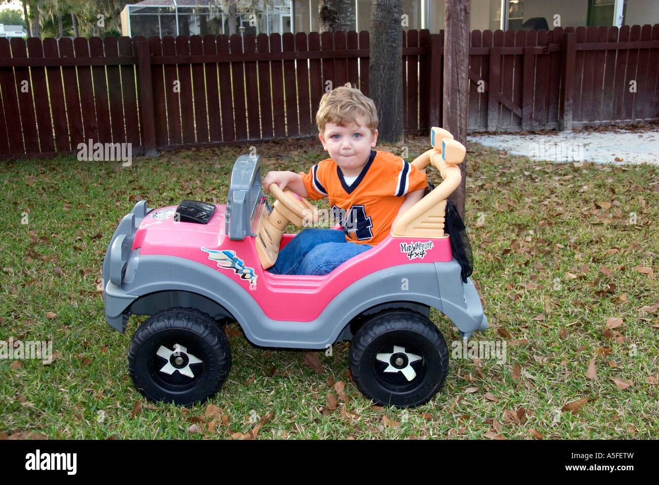 Three year old boy riding in a battery powered toy car Stock Photo - Alamy