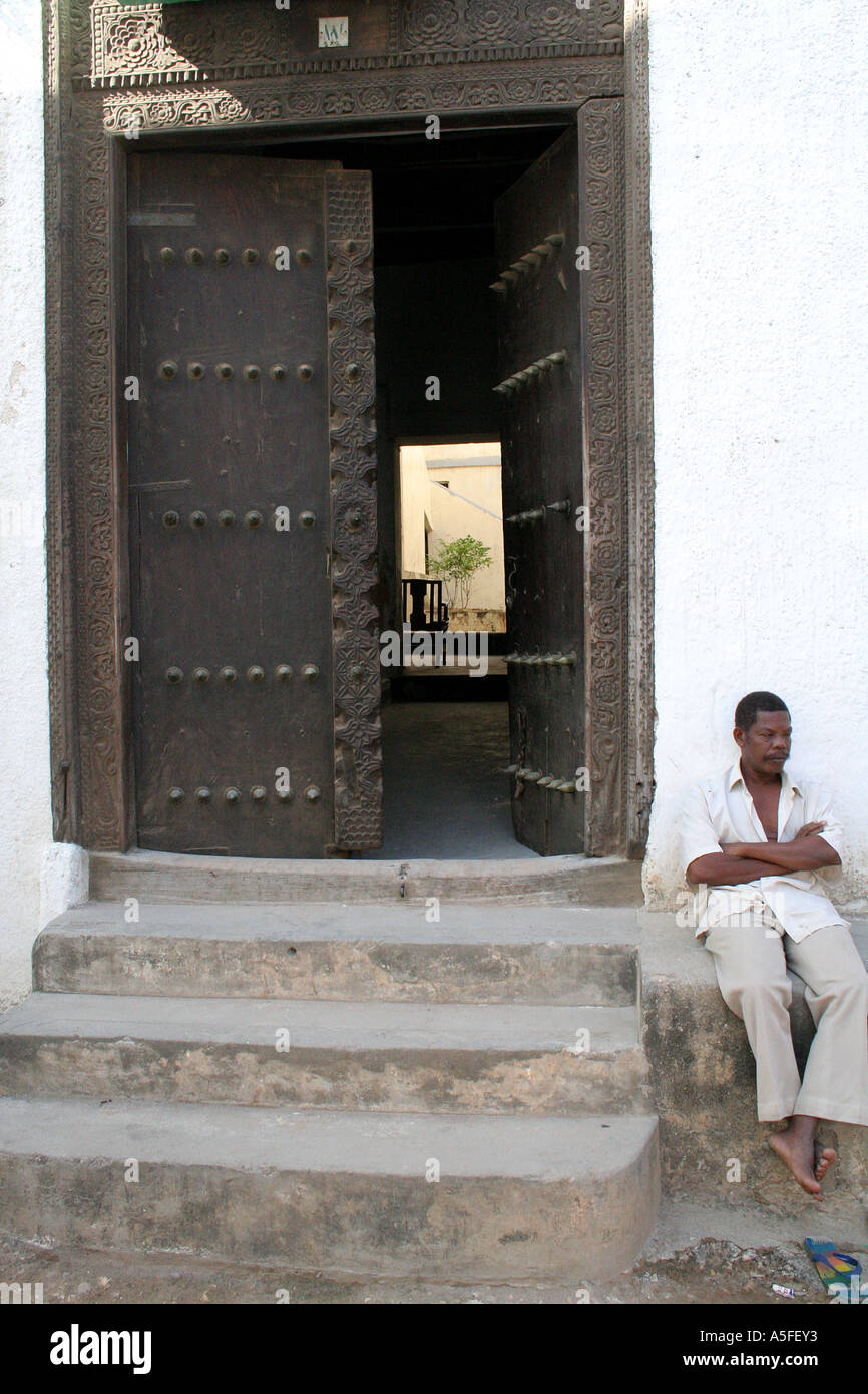 Zanzibar: Man sitting in front of a Zanzibari in Stonetown, Zanzibar ...