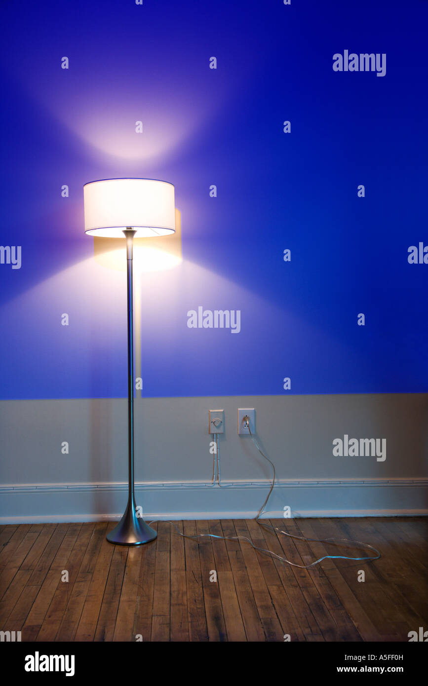 Blue projection light on wall with bright floor lamp Stock Photo - Alamy