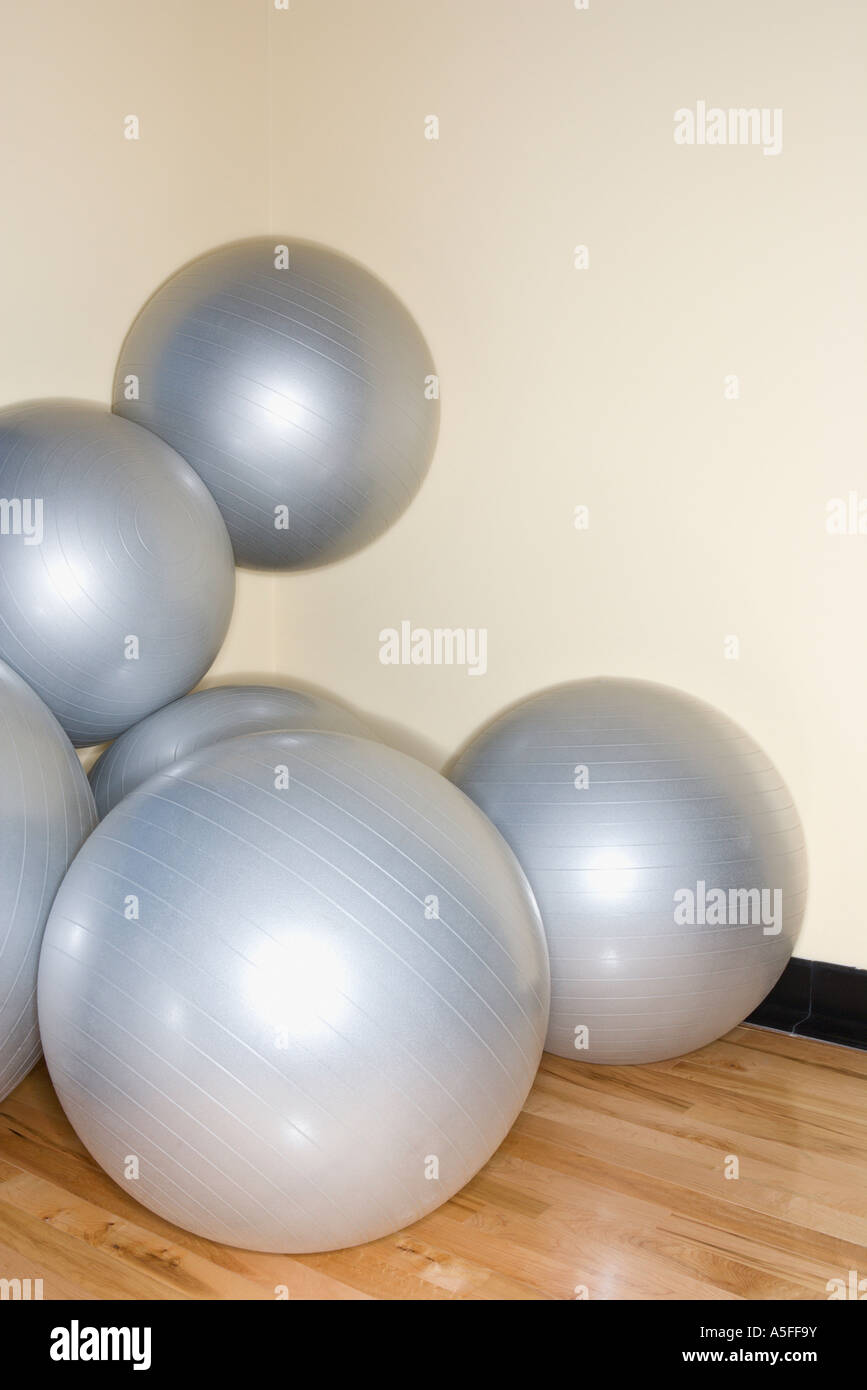 Balance balls stacked in gym Stock Photo - Alamy