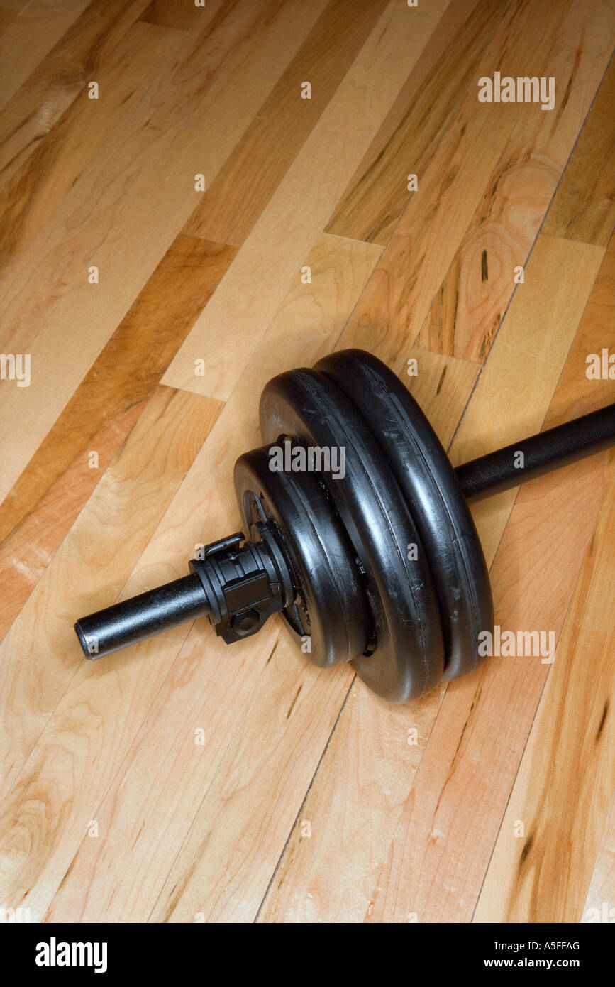 Barbell with weights on gym floor Stock Photo - Alamy