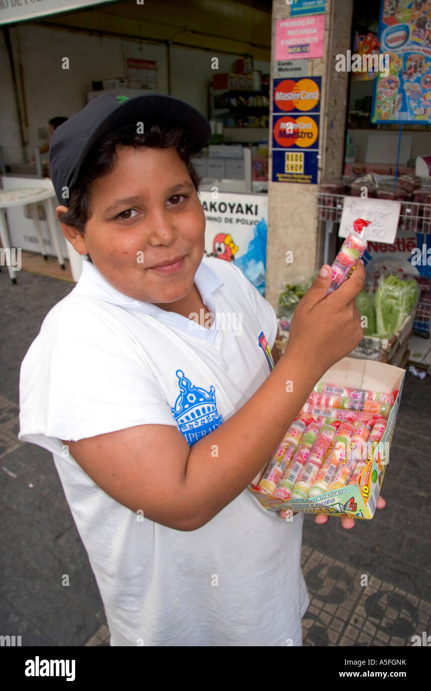 A boy selling candy on the street in the Liberdade asian section of Sao ...