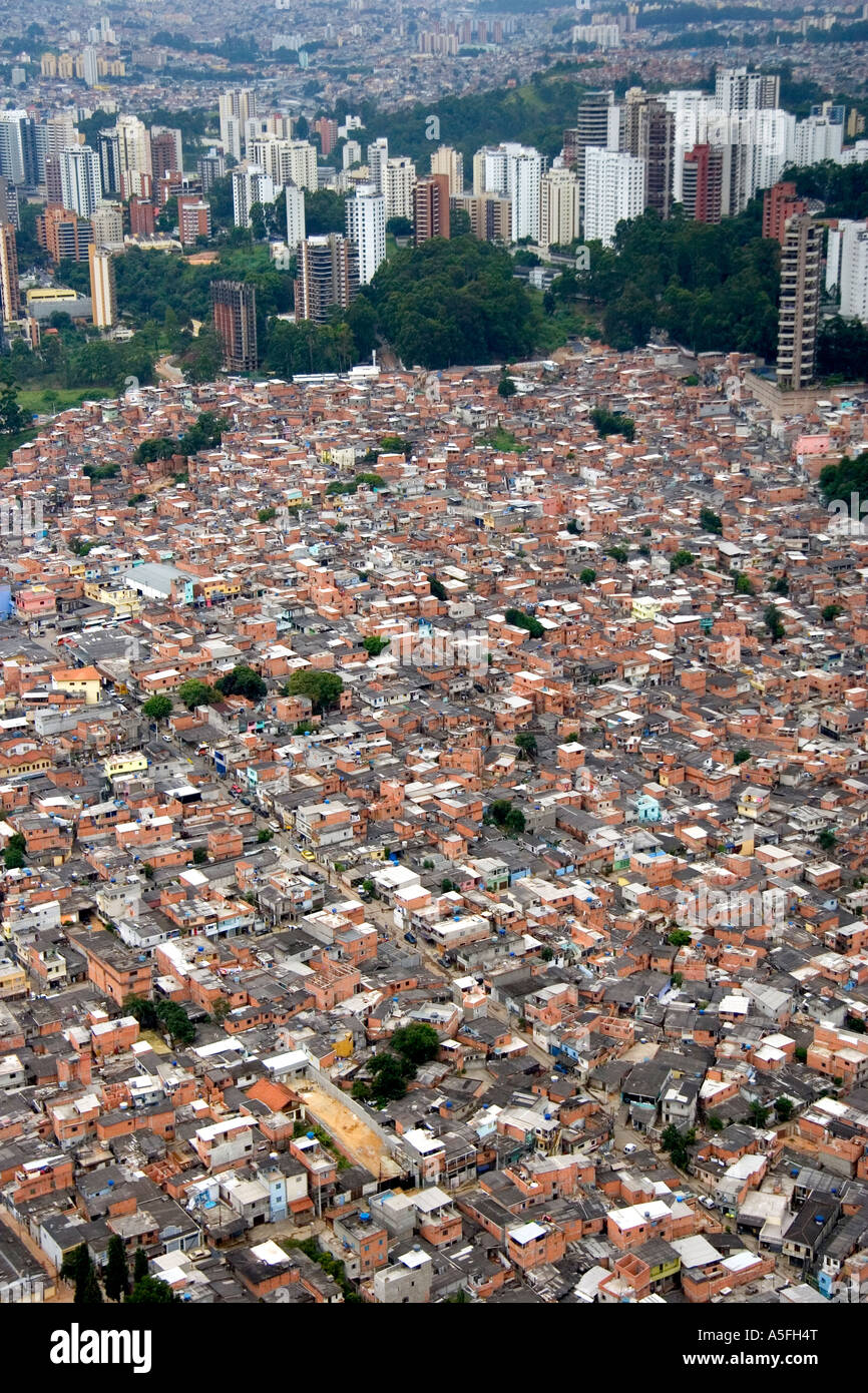 Aerial view of crowded favela housing contrasts with modern apartment ...