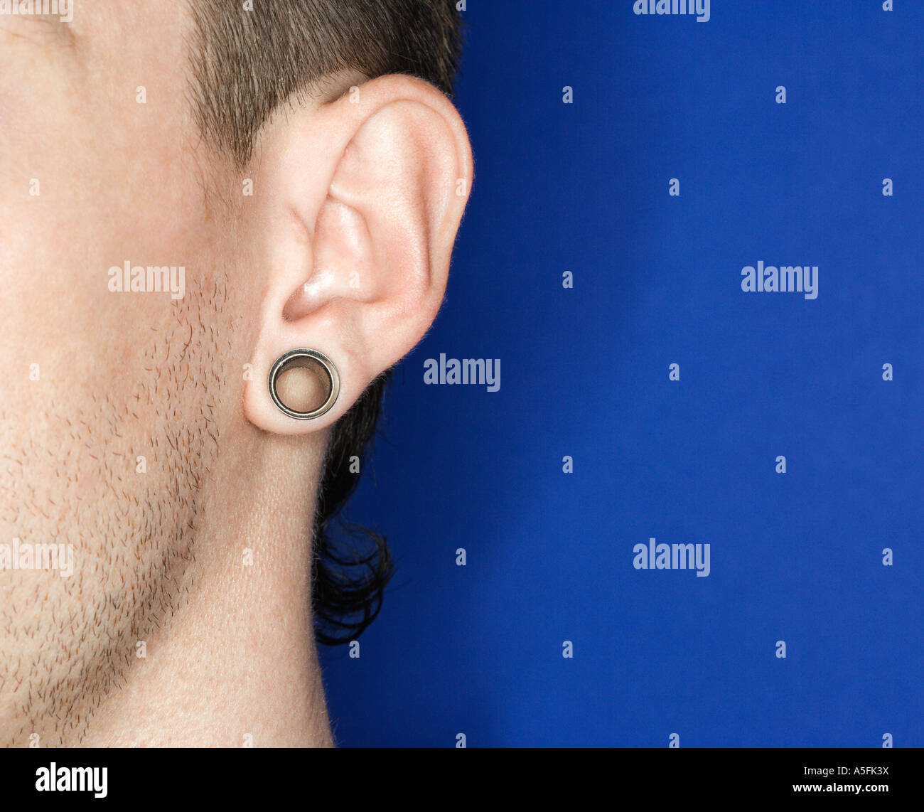 Young adult Caucasian male pierced ear Stock Photo - Alamy