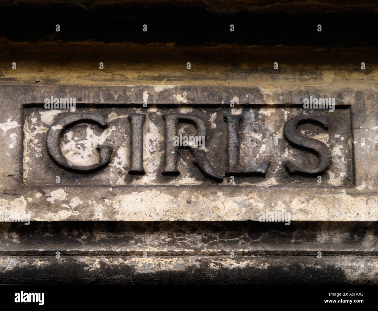 Sign carved in stone with the word girls photographed above the ...