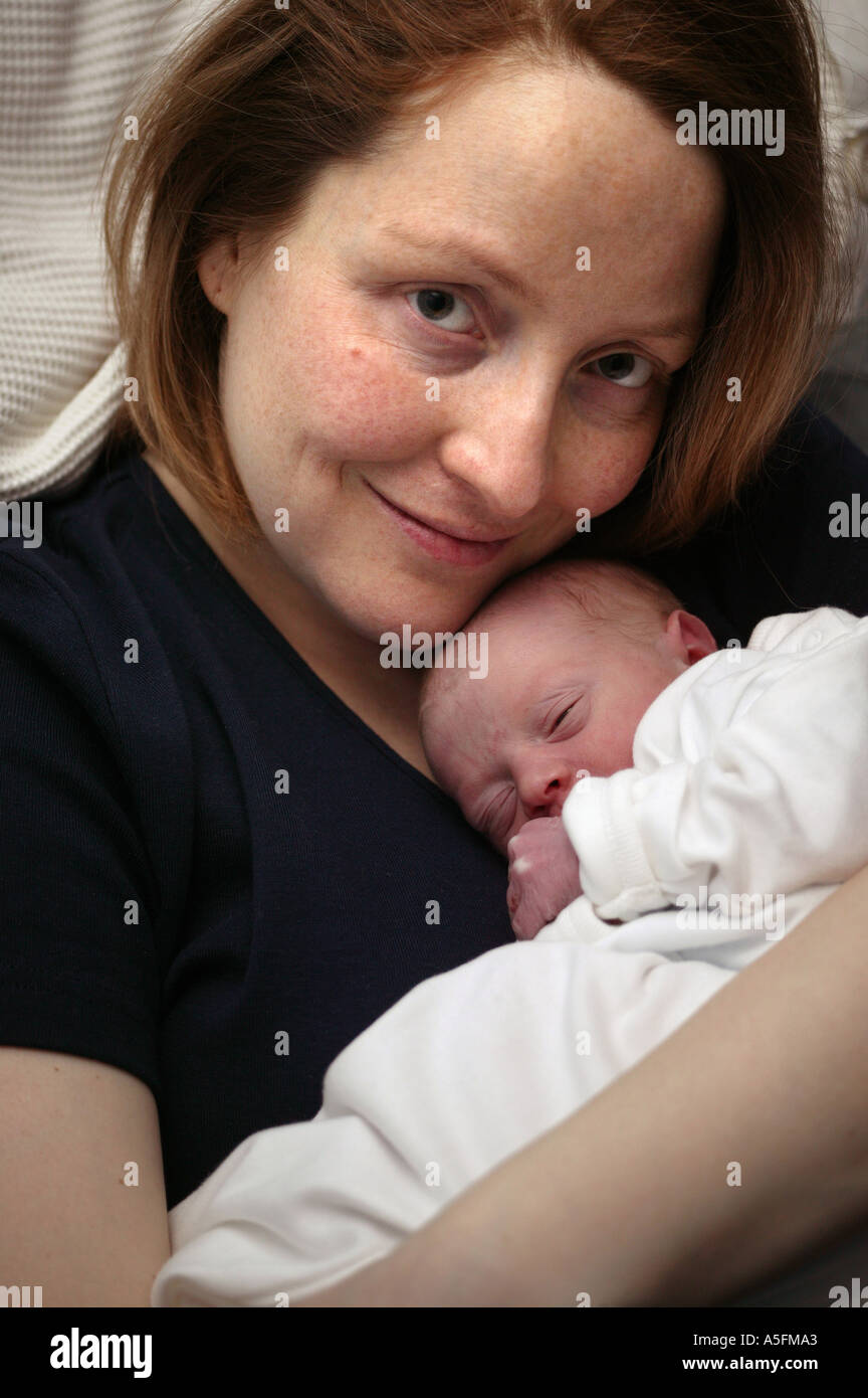 A contented mother with her newborn baby only minutes after the birth ...