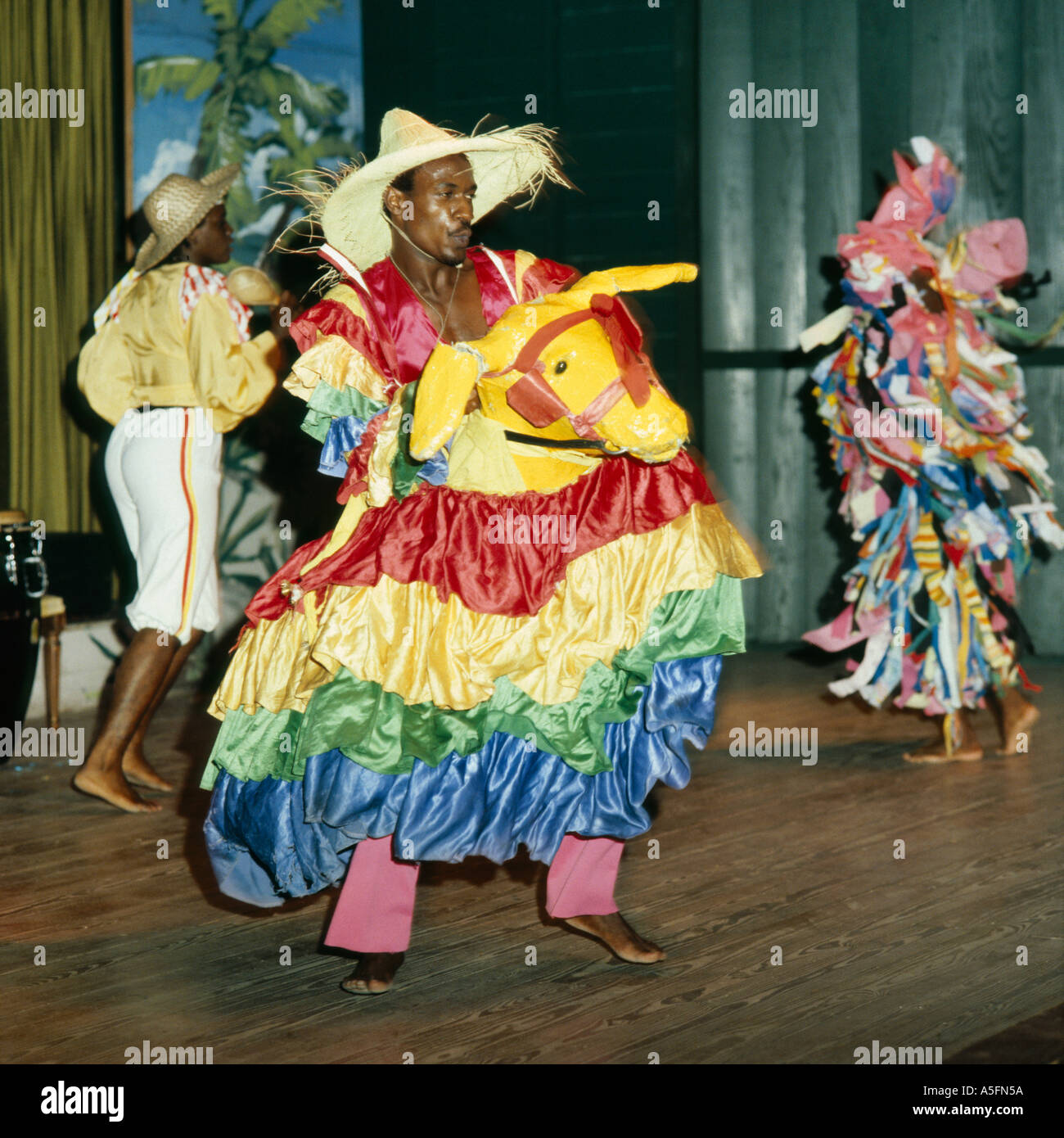 Barefooted man dressed as a hobby horse with big ears dances at ...