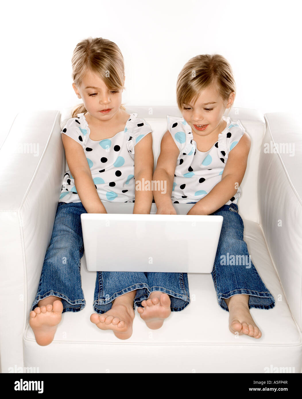 Female children Caucasian twins playing with laptop computer Stock ...