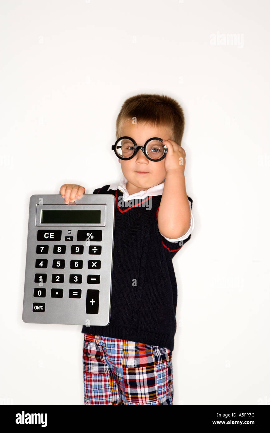 Caucasian male child wearing glasses and holding large calculator Stock ...