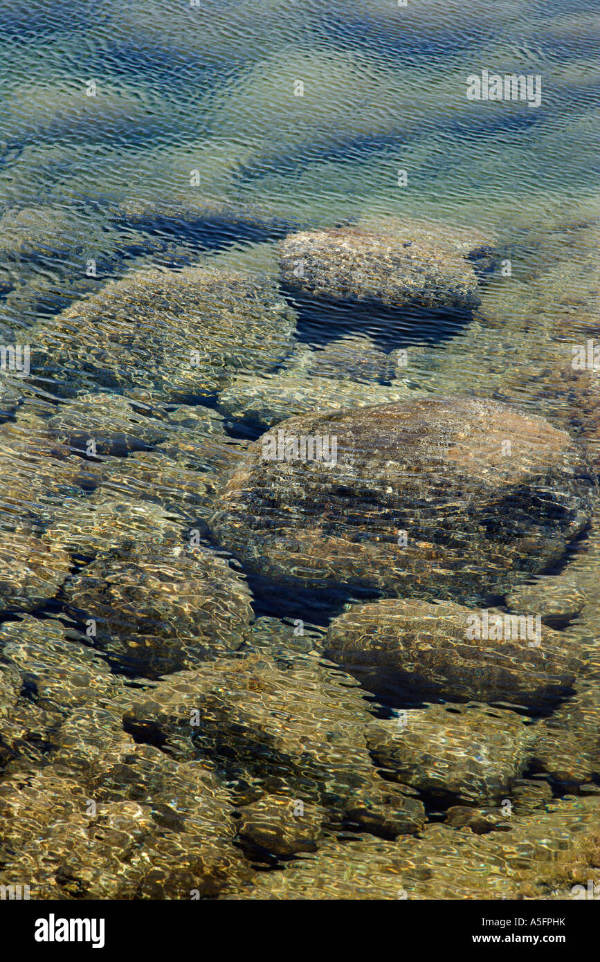 Rocks on ocean bottom seen through clear rippled water in Maui Hawaii ...
