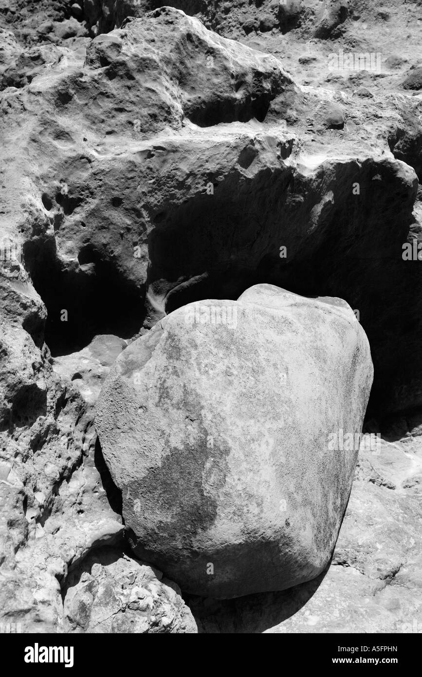 Large lava rock setting on rock cliff wall in Maui Hawaii Stock Photo ...