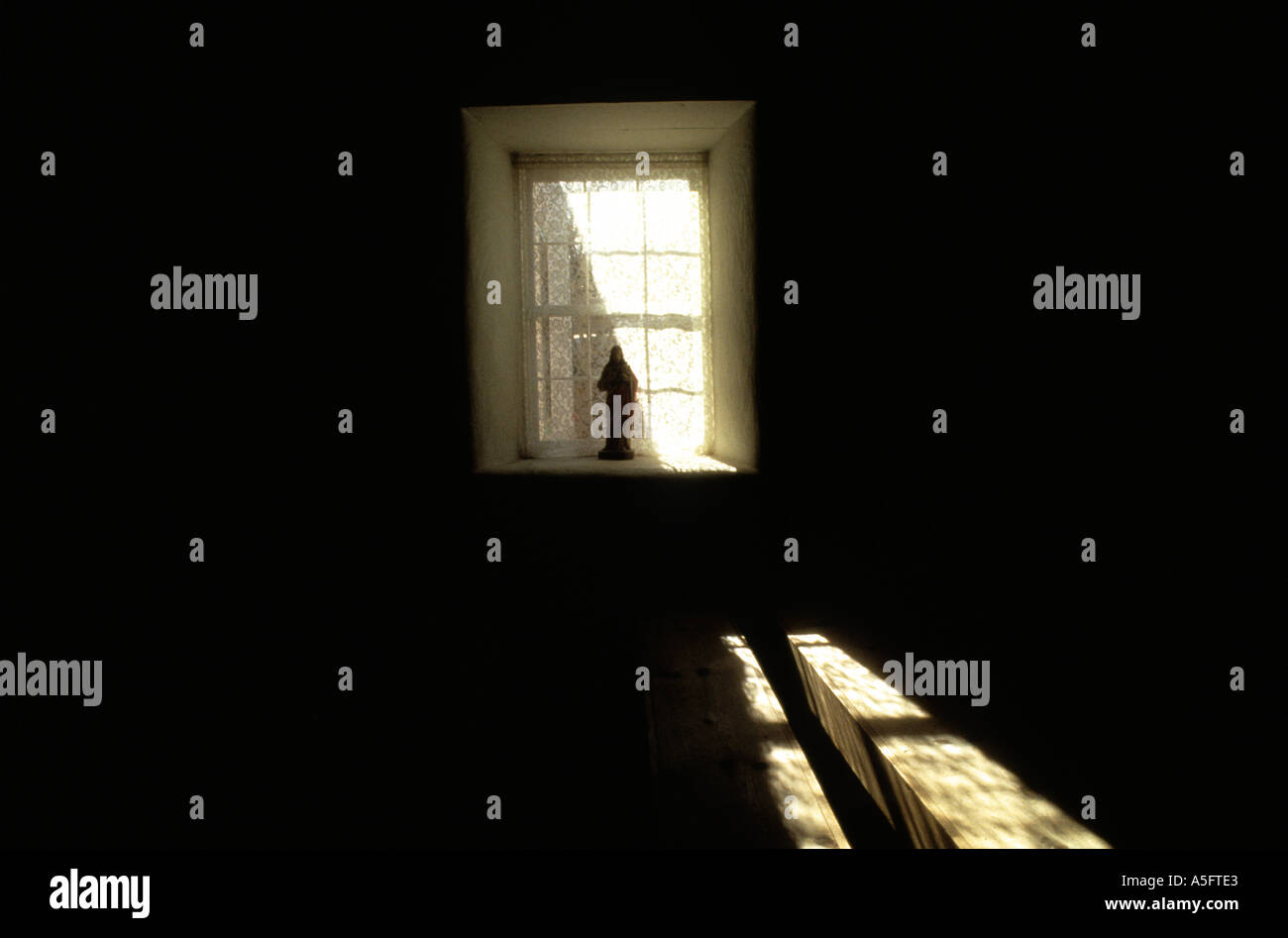 A statue of the Blessed Virgin Mary cats a shadow in a Taos New Mexico ...