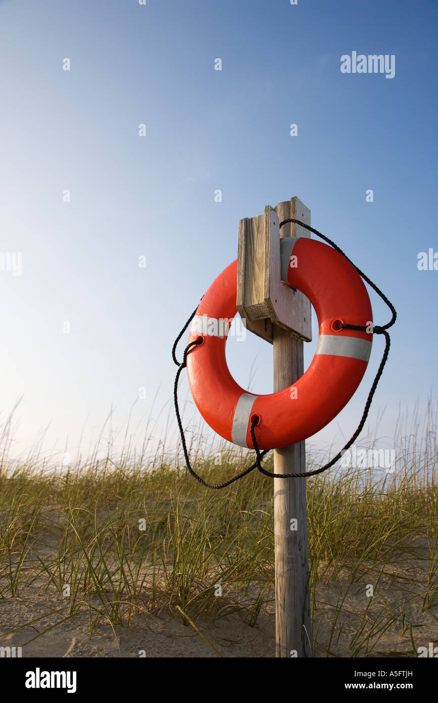 Life preserver hanging on post on beach on Bald Head Island North ...