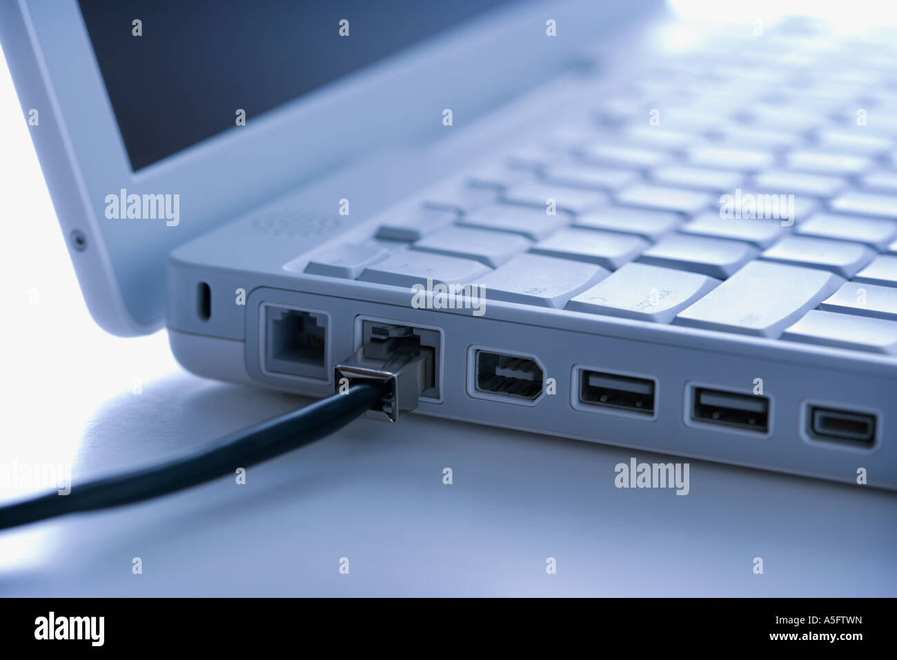 Data wire connected to laptop computer Stock Photo - Alamy