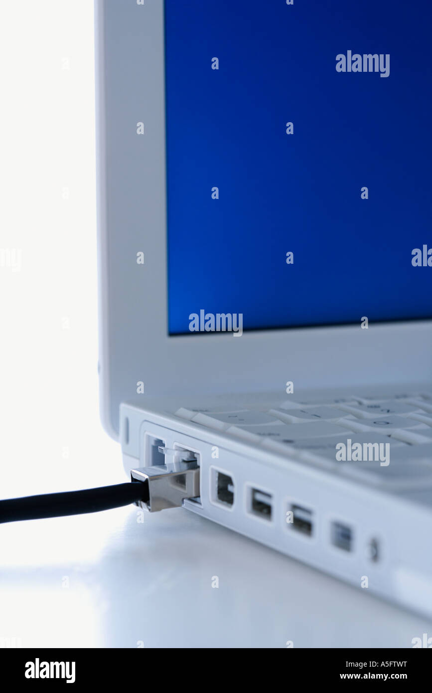 Close up of data wire plugged into laptop computer Stock Photo - Alamy