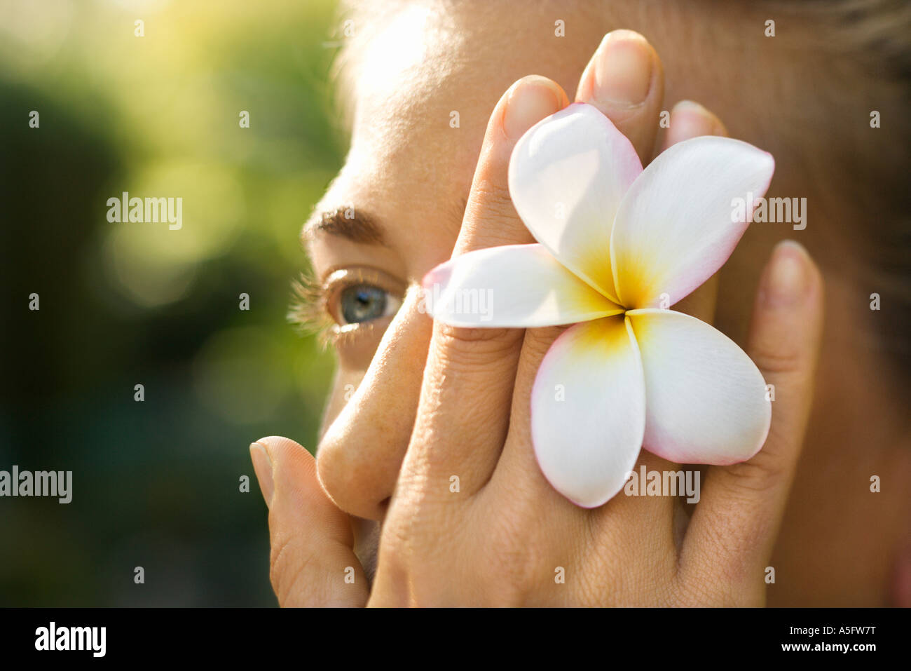 Woman flower over one eye hi-res stock photography and images - Alamy