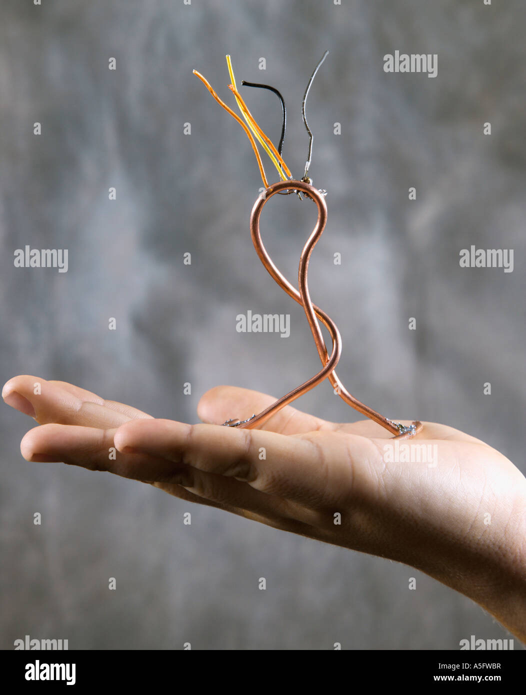 Male Caucasian adolescent hand holding wire sculpture Stock Photo - Alamy