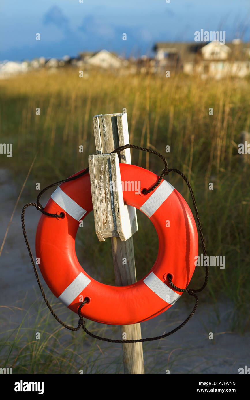 Life preserver hanging on post on beach Stock Photo - Alamy