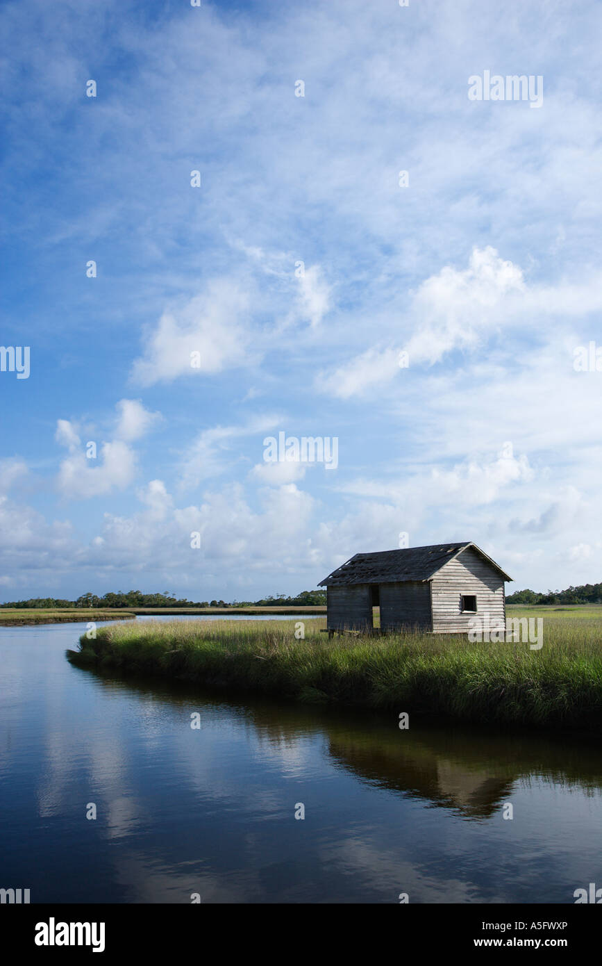 Weathered building in marsh on creek Stock Photo - Alamy