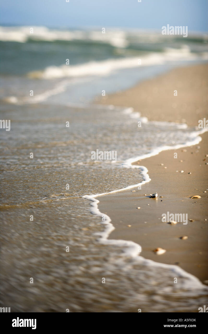 Waves coming onto shore Stock Photo - Alamy