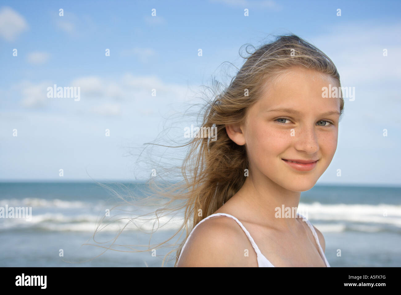 Caucasian pre teen girl on beach looking at viewer Stock Photo - Alamy