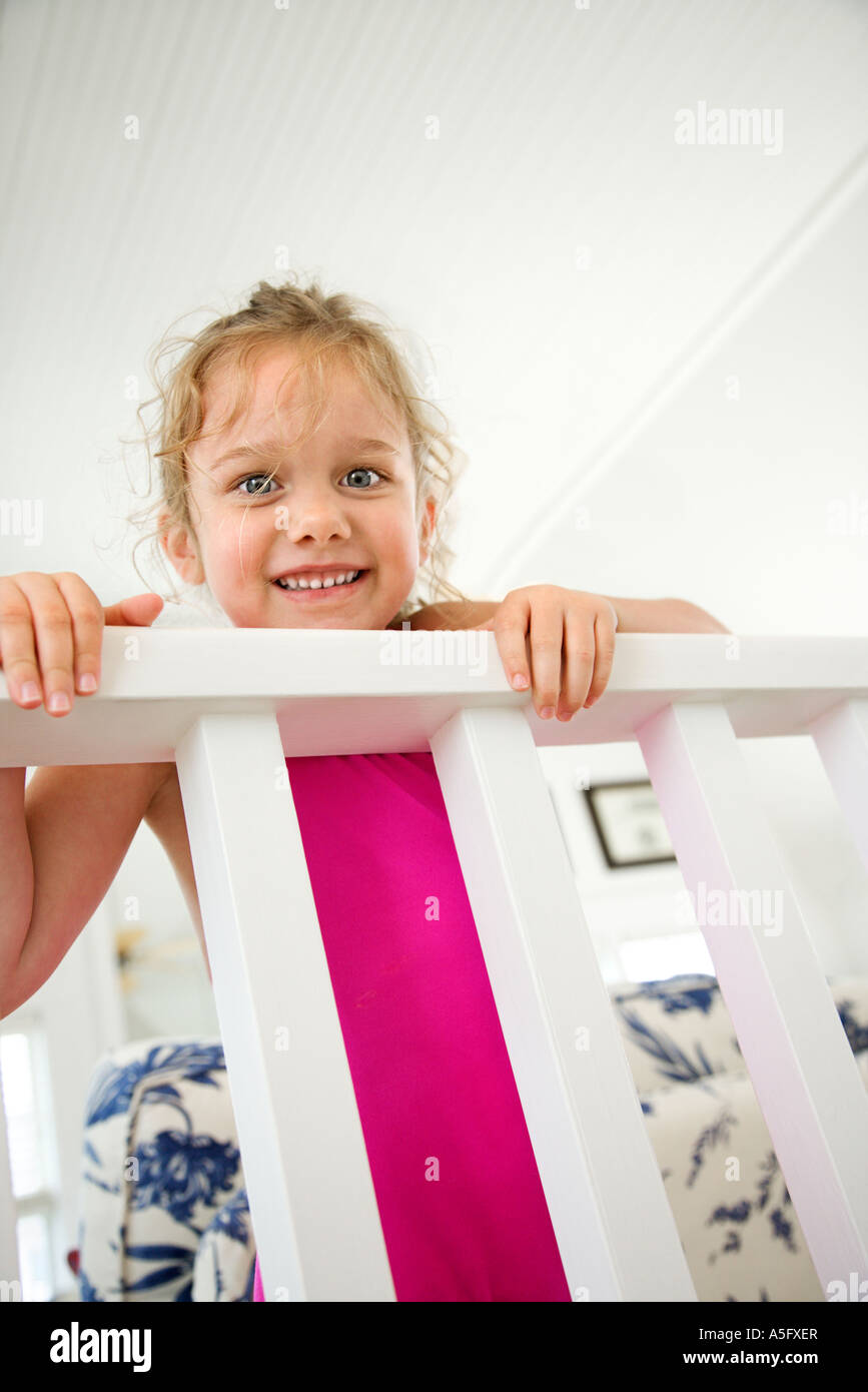 Caucasian female child peeking over railing Stock Photo - Alamy