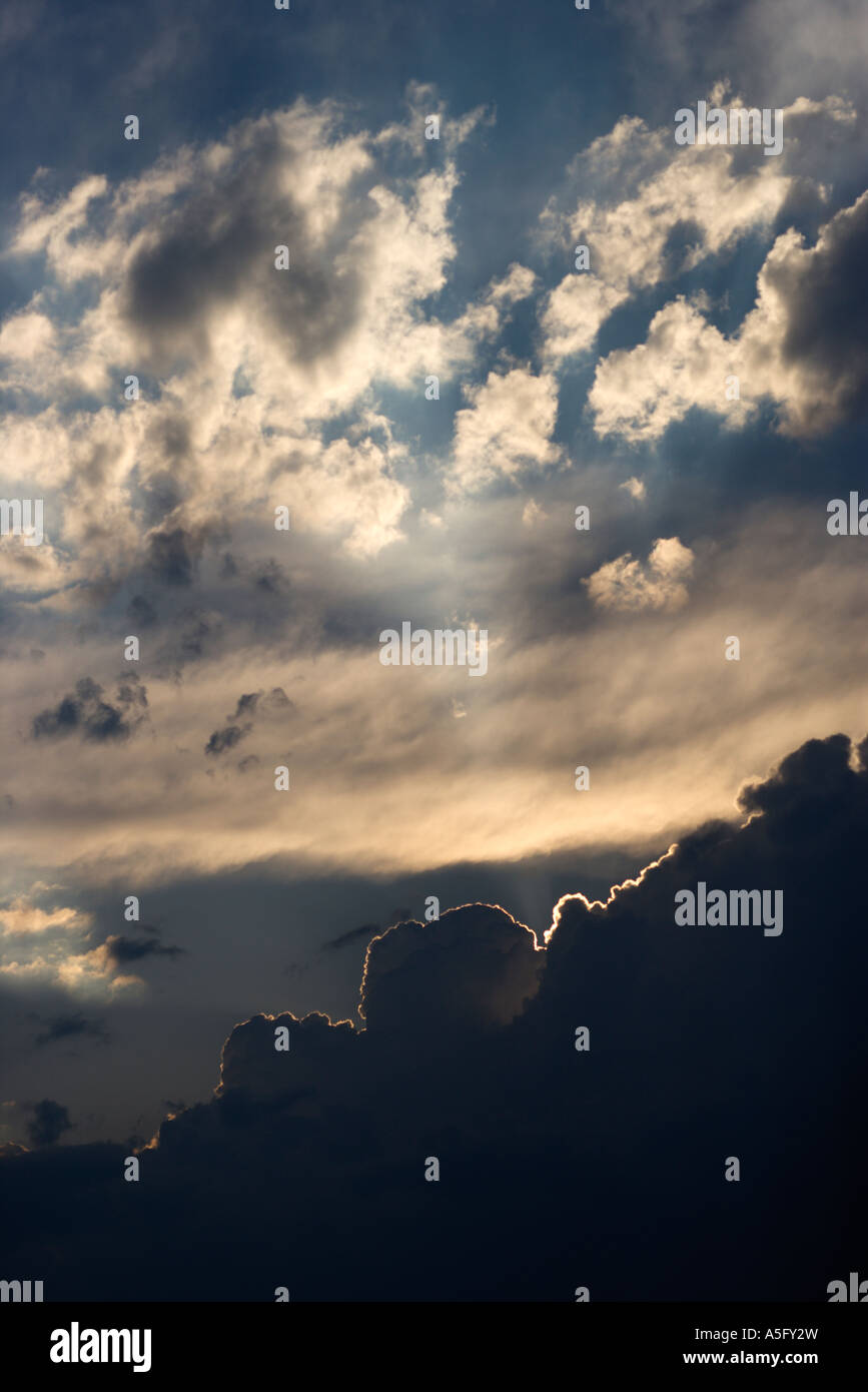 Sun peeking through clouds Stock Photo - Alamy