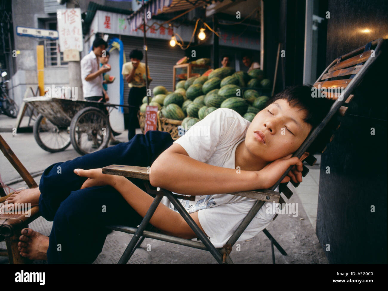 Shop worker asleep in the street Shanghai China Images of economic ...