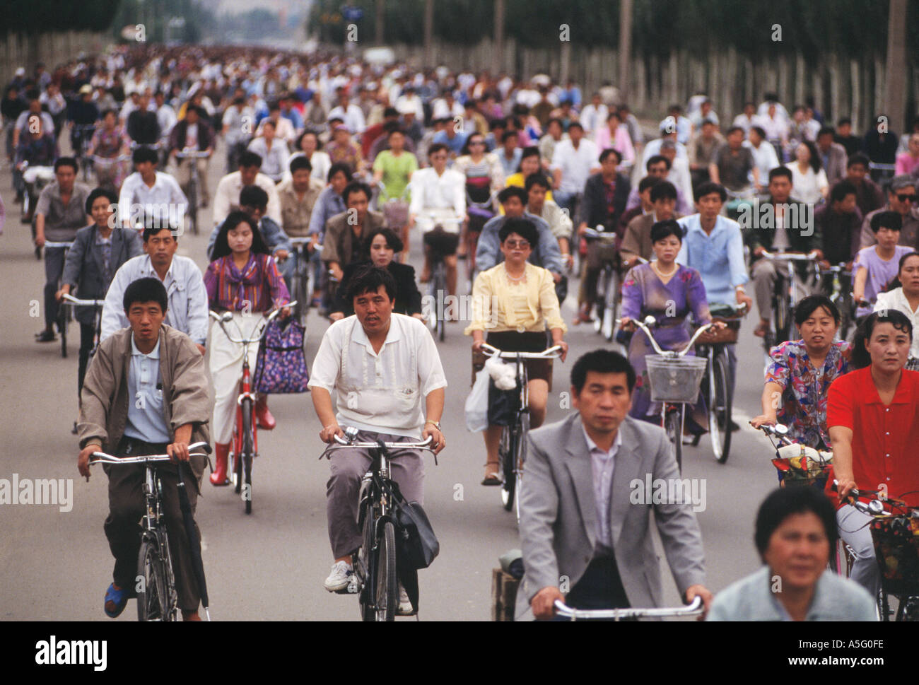 Workers cycling home from work at Bautou Steel factory Inner Mongolia ...